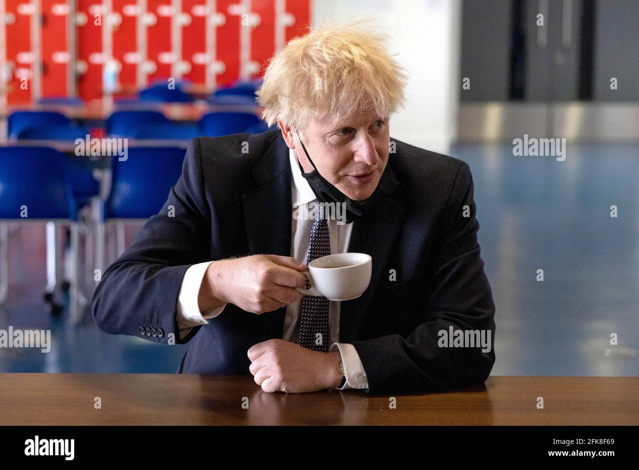 Prime Minister Boris Johnson drinks a coffee whilst speaking with ...
