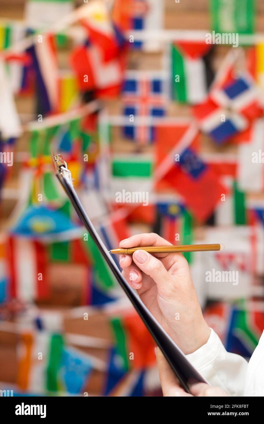 Travel agency manager writes information in notebook Stock Photo - Alamy