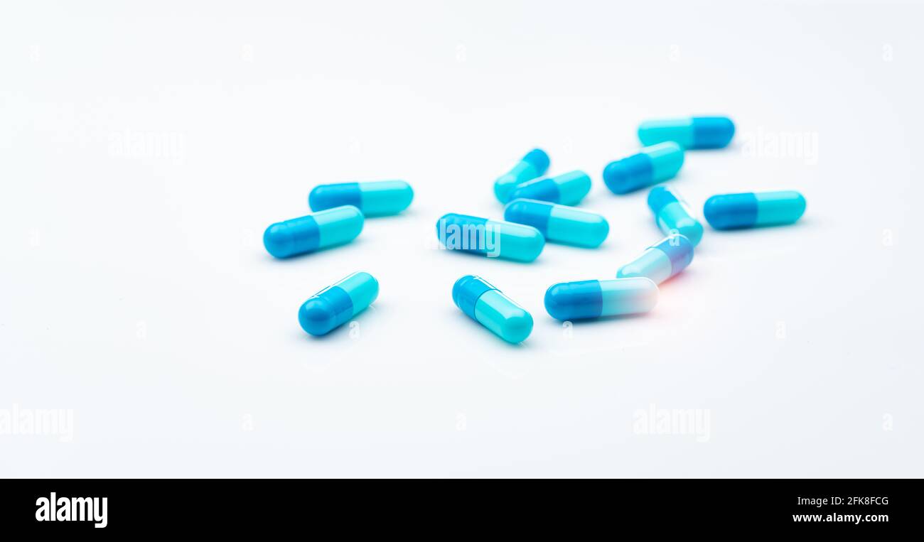 Blue antibiotic capsule pills spread on white background. Antibiotic ...
