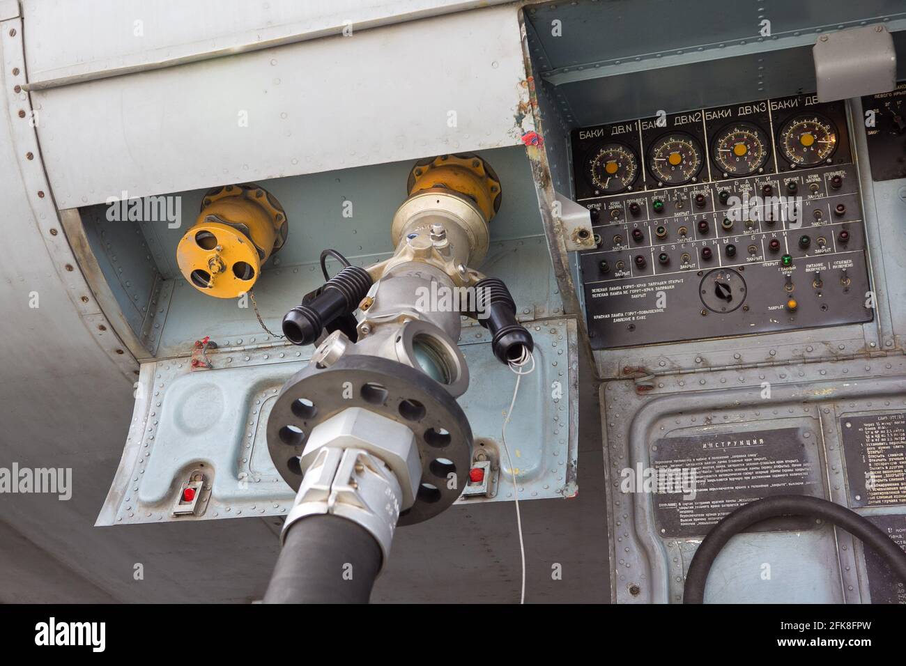 The process of refueling airplane in airport. Fuel hose is inserted ...