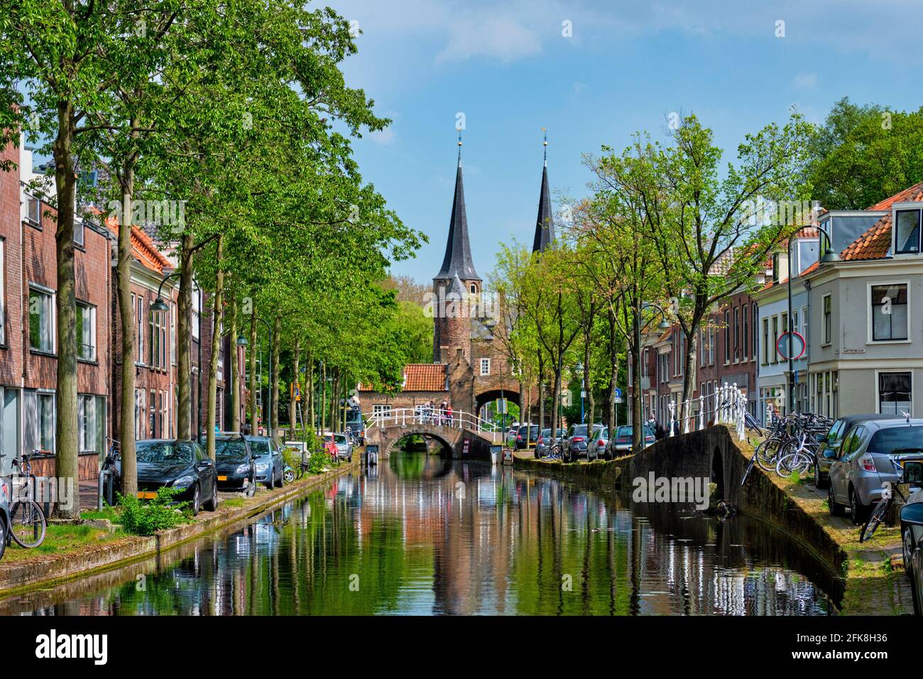 Delft cityscape view with Eastern Gate Oostport and canal with cars and ...