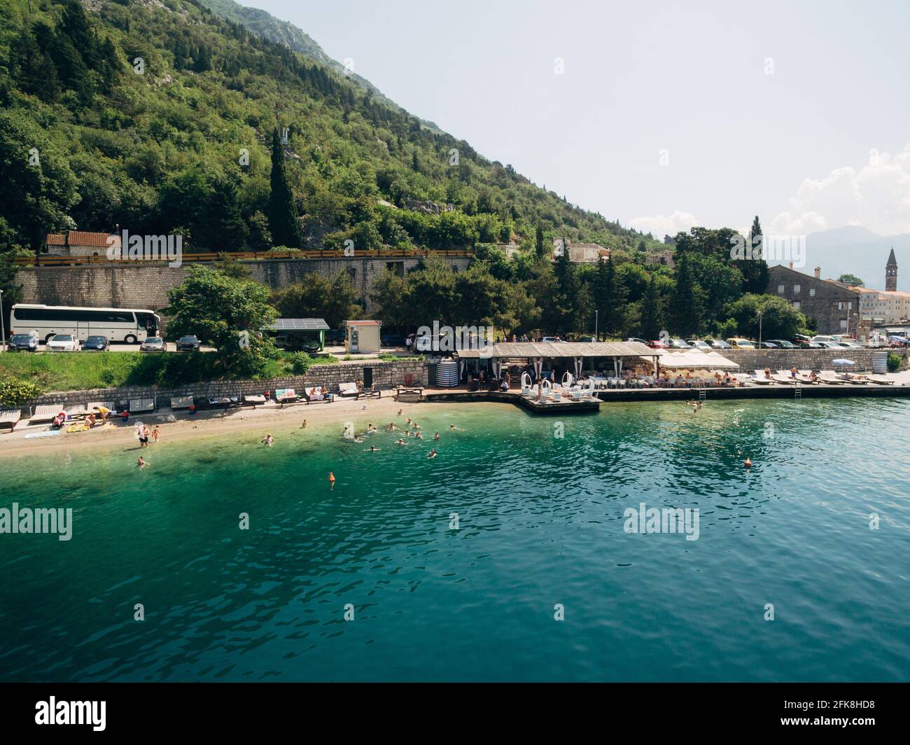 Aerial view of the beach of Perast city with various buildings and ...