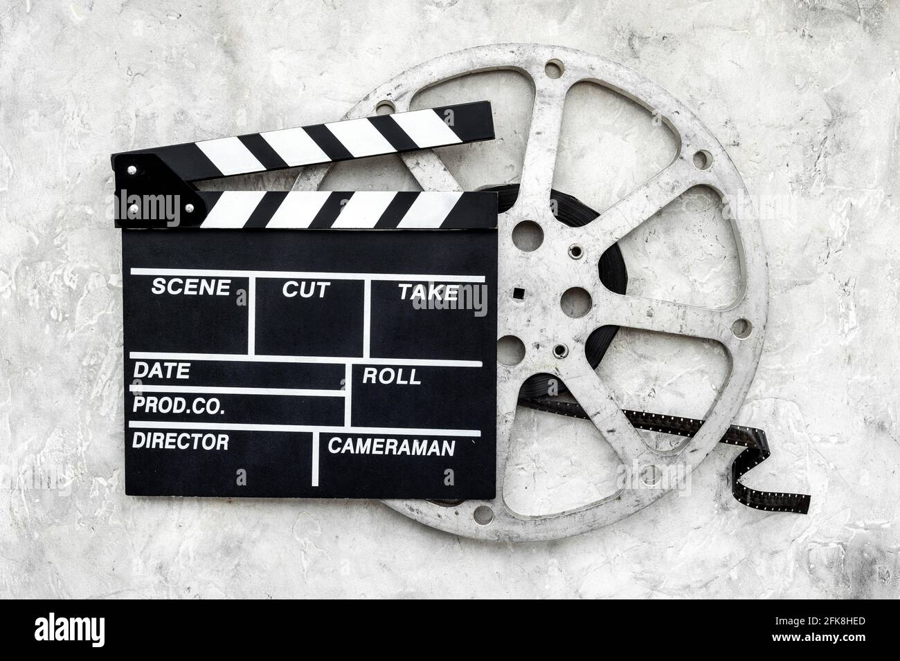Movie film reel with clapperboard. Cinema concept Stock Photo - Alamy