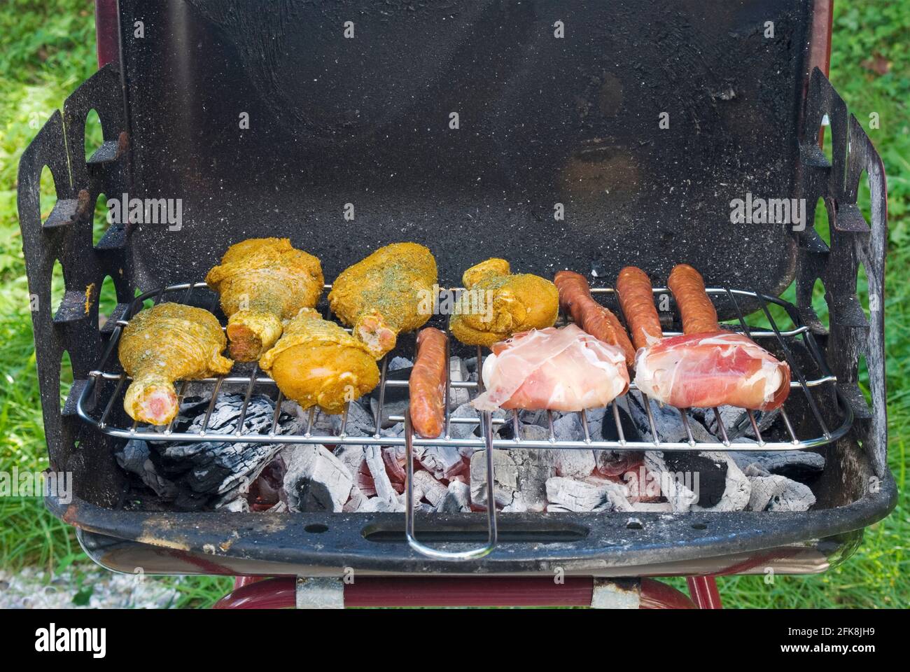 BBQ fire over the hot coals with meat assortment Stock Photo - Alamy