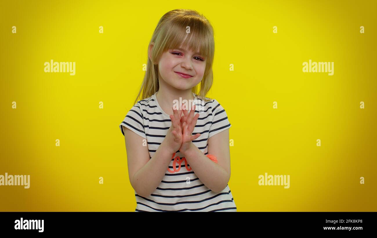Cunning sneaky playful child girl with tricky face gesticulating and ...