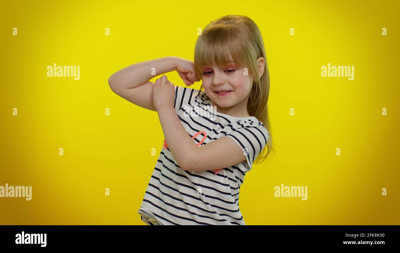 Little strong kid child girl showing biceps and feeling power strength ...
