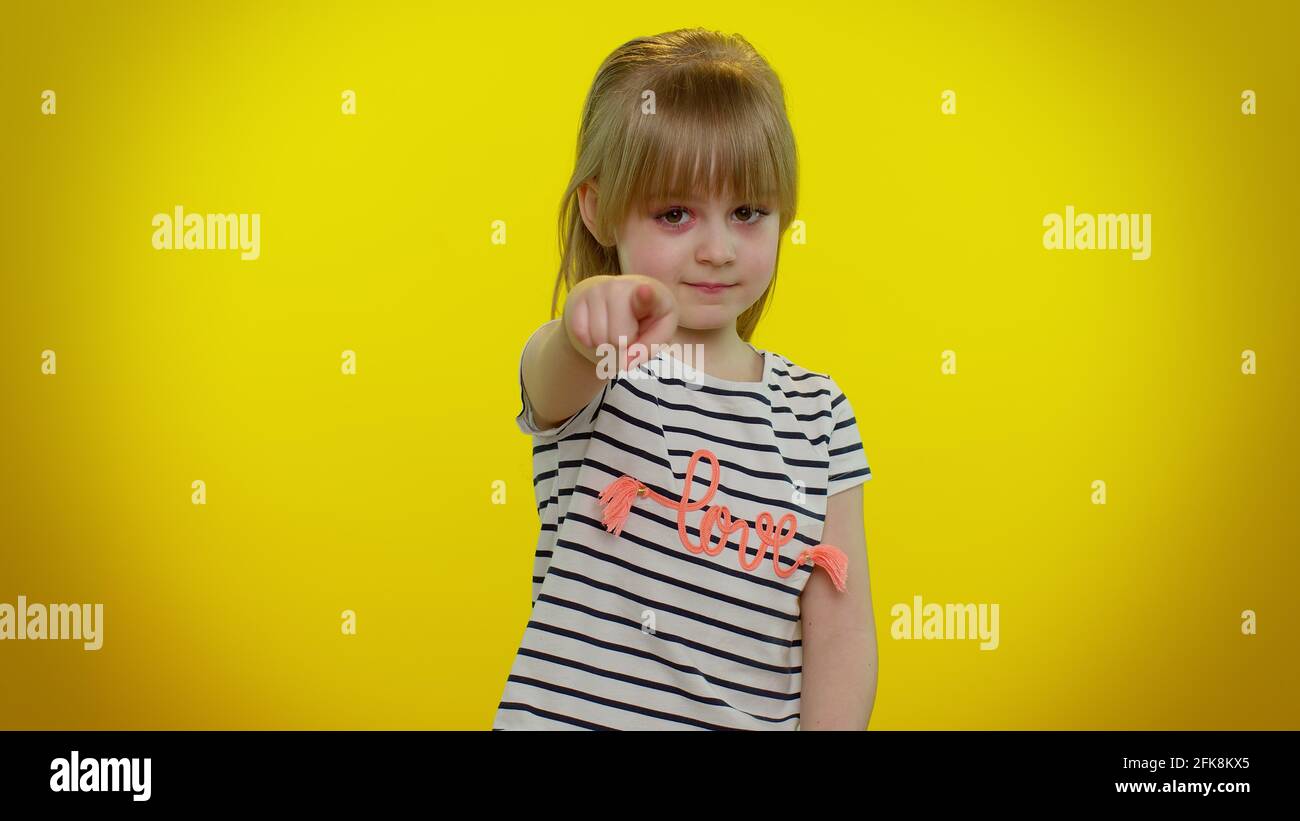 Kid child girl pointing to camera, looking with playful expression ...