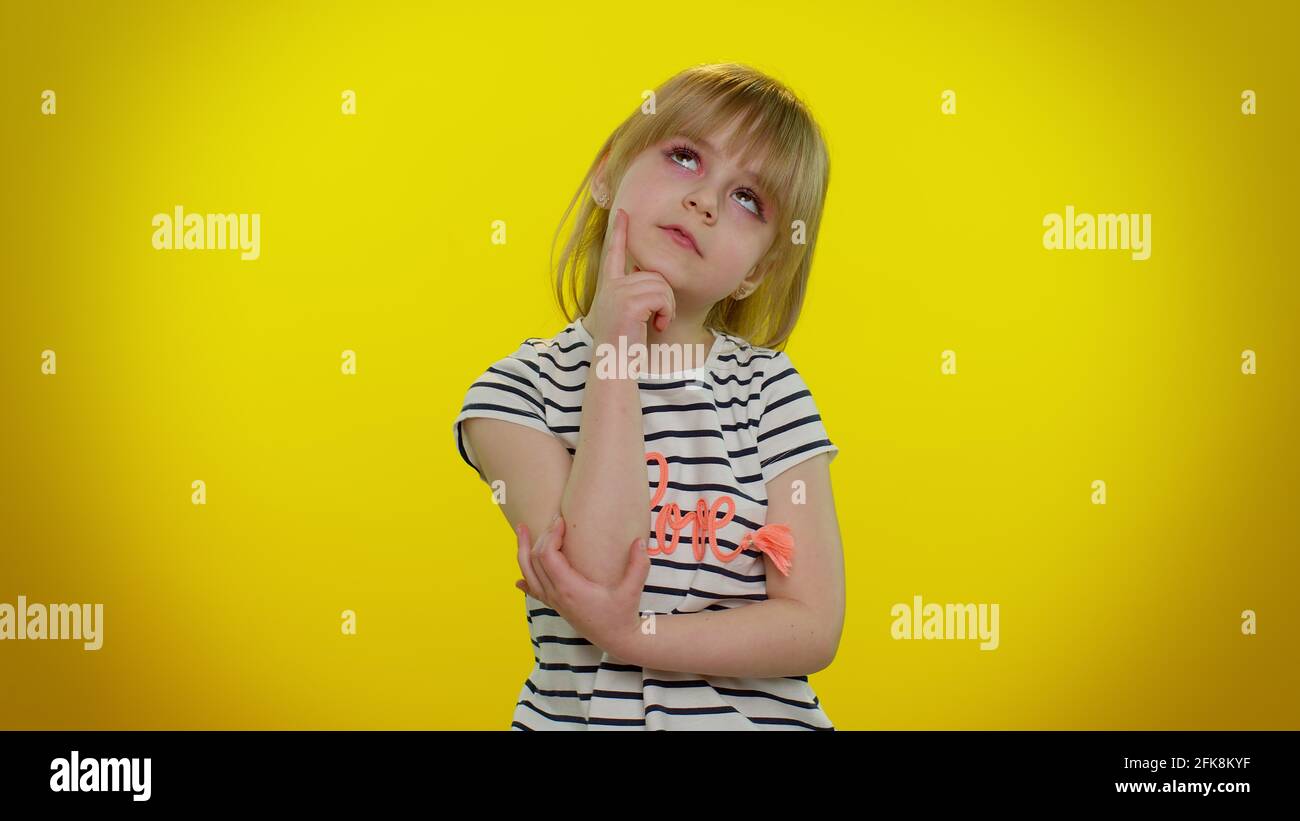 Doubting pensive little child kid girl wondering difficult solution ...