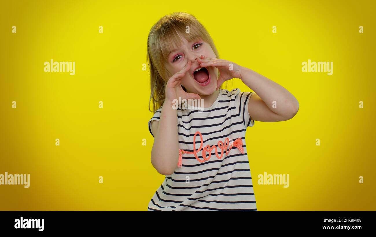 Little blonde teen kid child girl in t-shirt shouting hello, waving ...