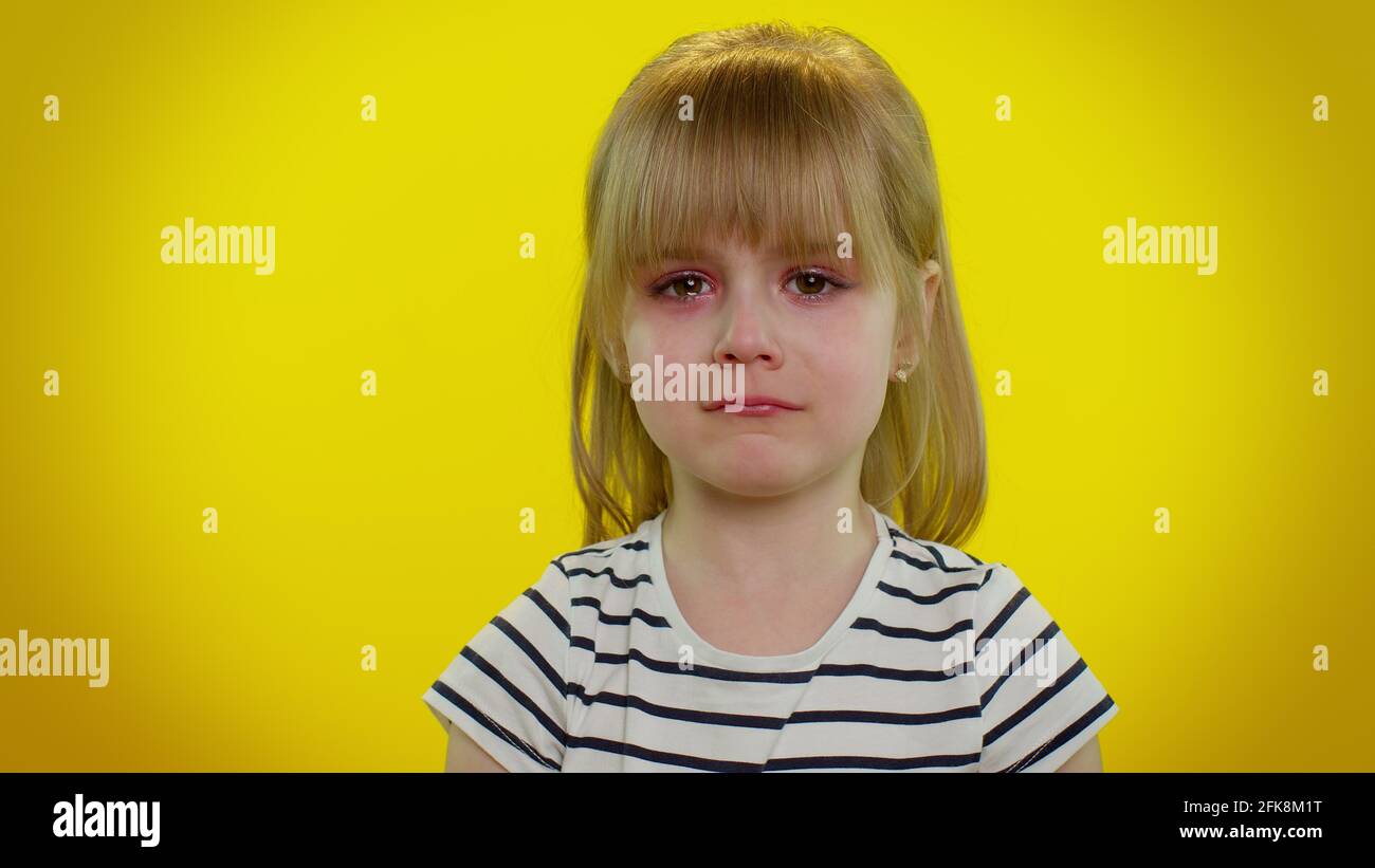 Disappointed upset kid child girl with tears on eyes cries from despair ...