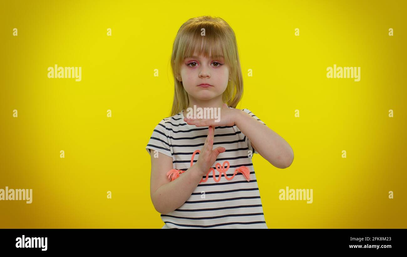 Tired blonde child girl showing time out gesture, limit or stop sign no ...