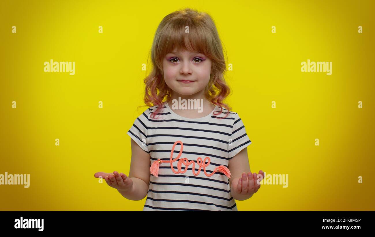 Frustrated child kid girl raising hands in indignant expression asking ...