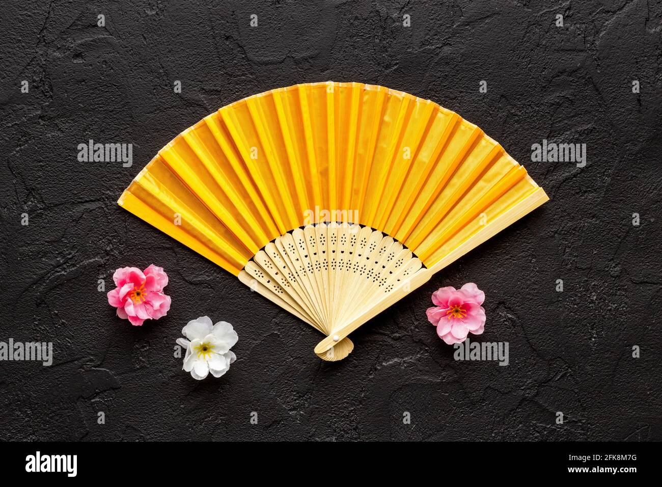 Yellow golden hand fan made of bamboo and paper. Top view Stock Photo ...
