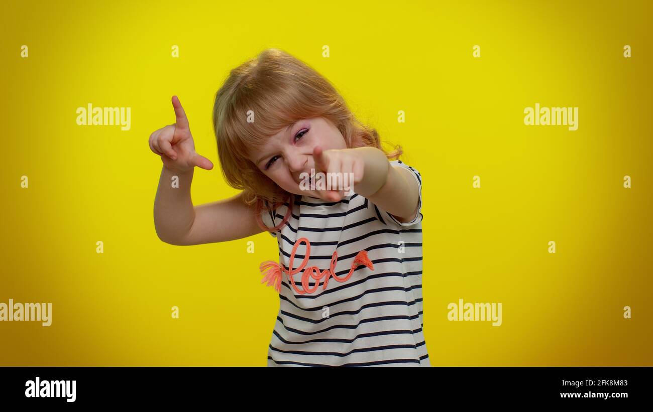Child girl showing loser gesture and pointing on you, blaming accusing ...