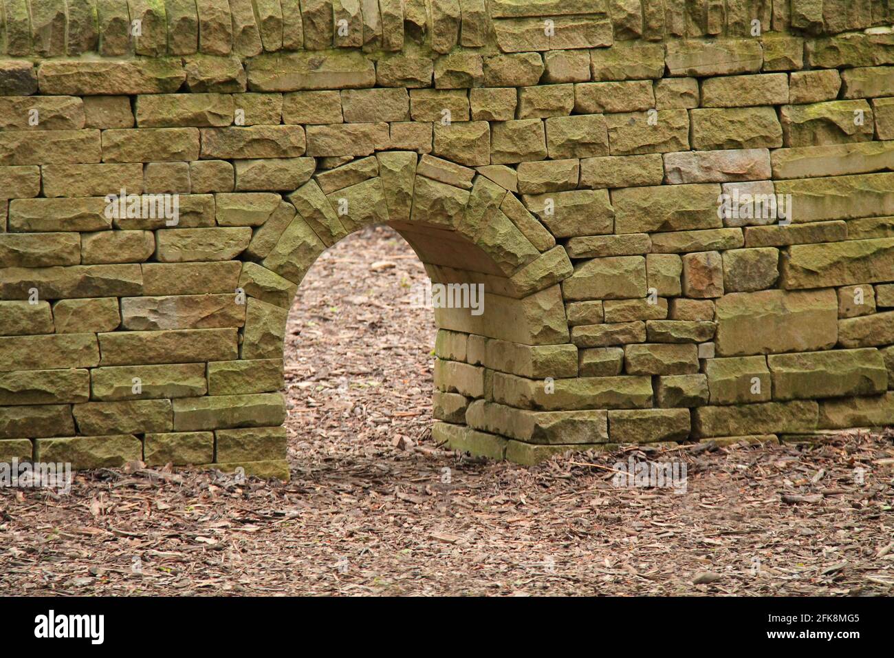 A Stone Built Wall with a Small Archway Through It Stock Photo - Alamy