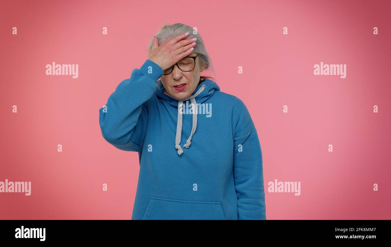 Upset senior granny woman making face palm gesture, feeling bored ...