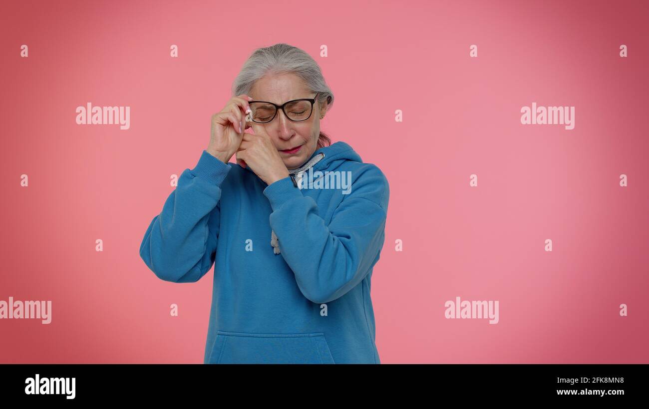 Upset disappointed senior old woman wipes tears and cries from despair ...