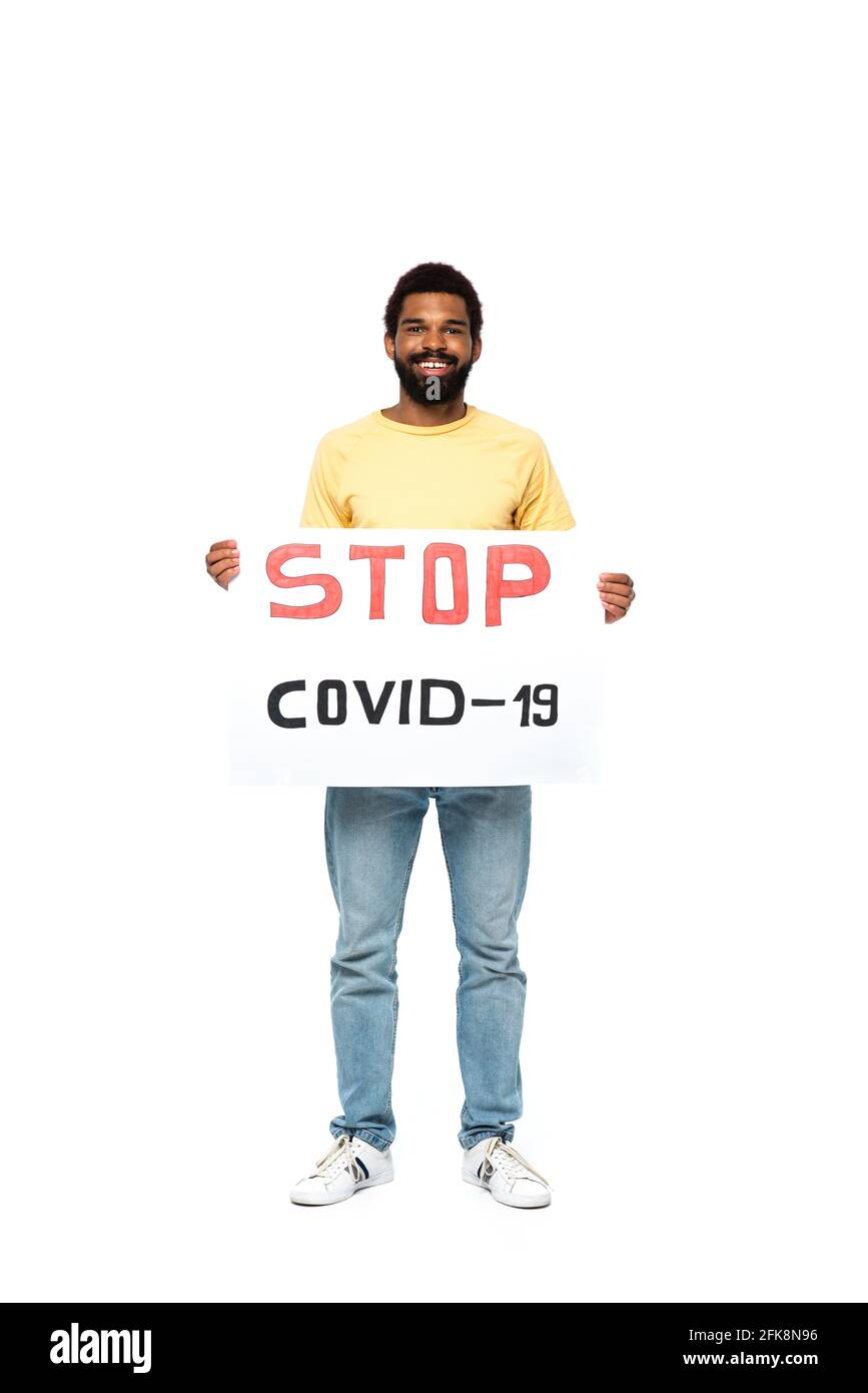 Positive african american man holding placard with stop covid-2019 ...
