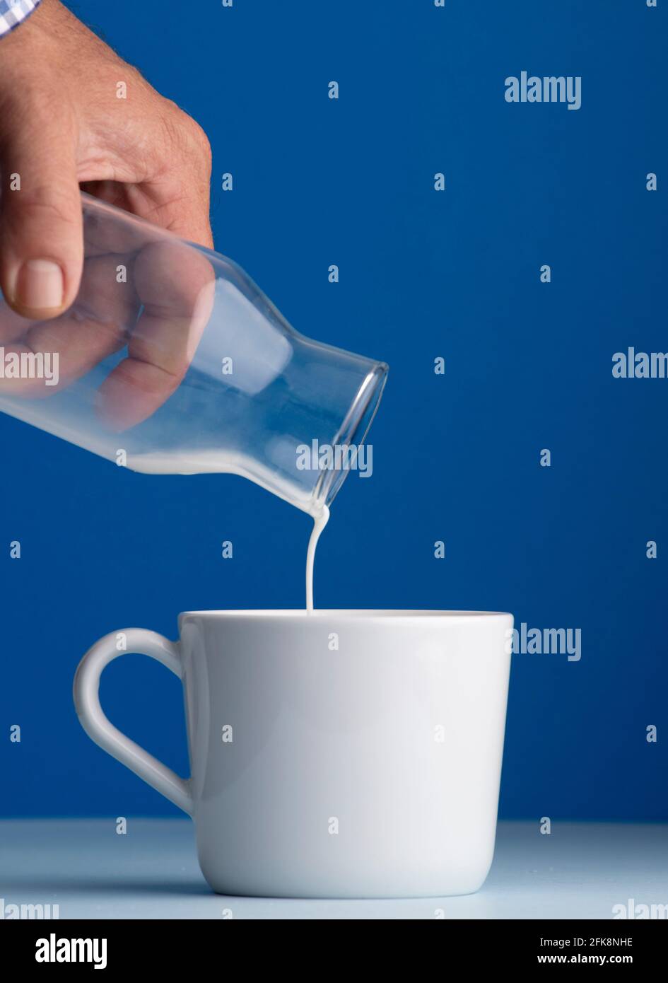 milk ran out, white cup blue background Stock Photo - Alamy