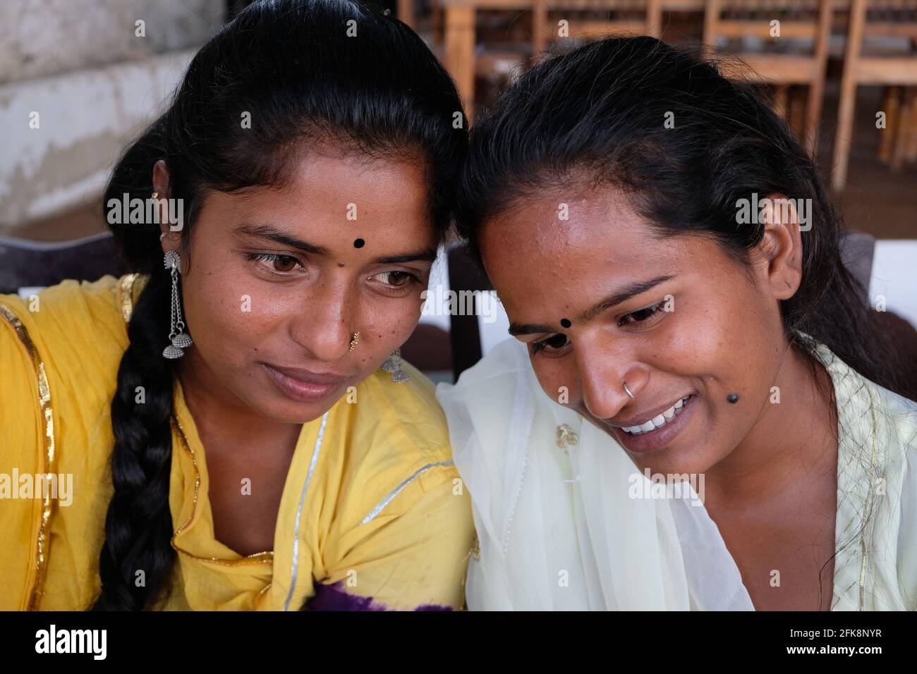 Young Indian female friends enjoying their time in a cafe Stock Photo ...