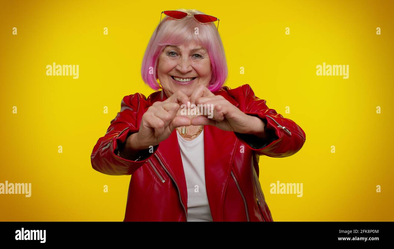 Smiling senior woman makes heart hi-res stock photography and images ...