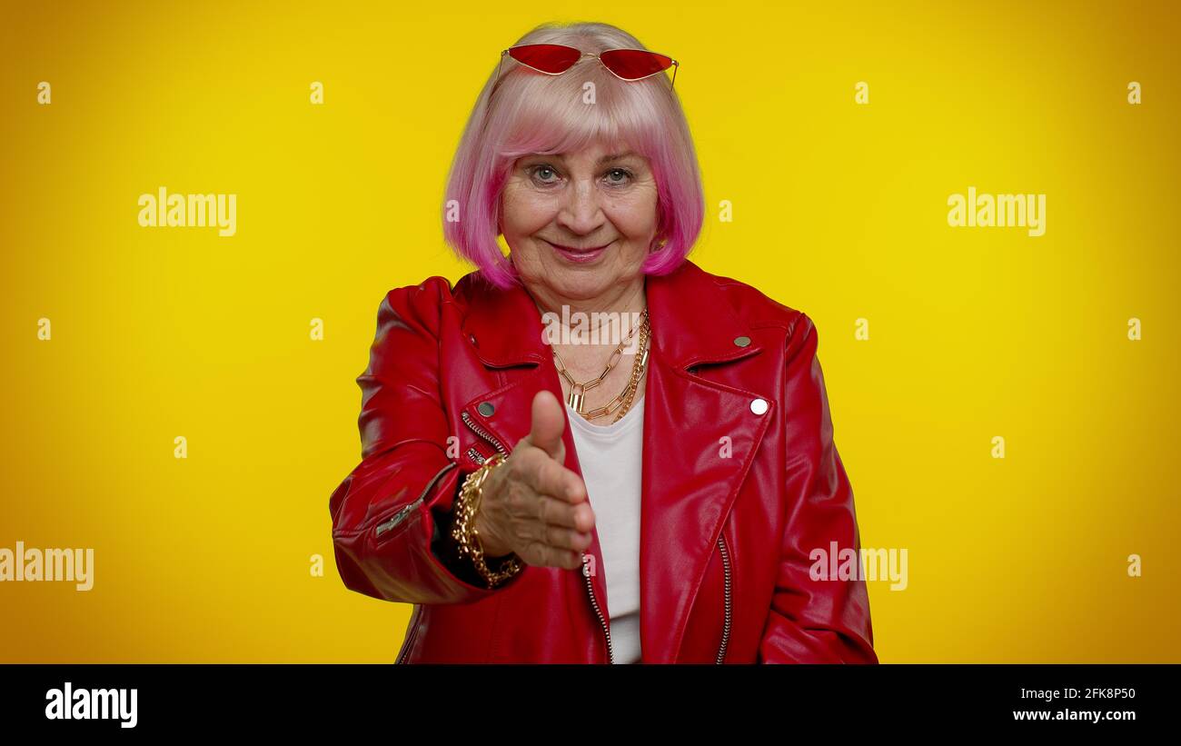 Friendly senior woman outstretching hand hi-res stock photography and ...