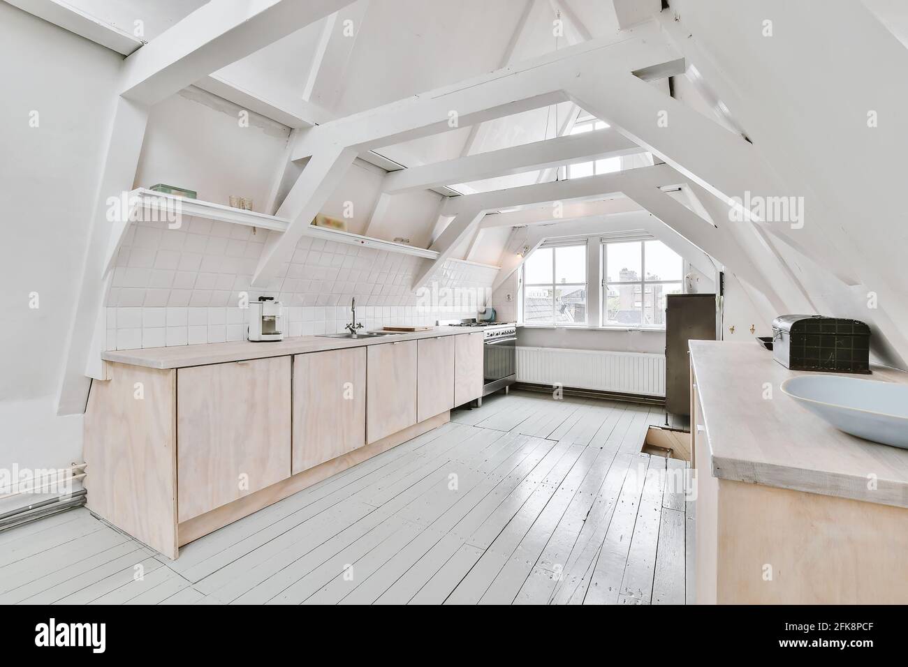 Simple kitchen in attic studio apartment Stock Photo - Alamy