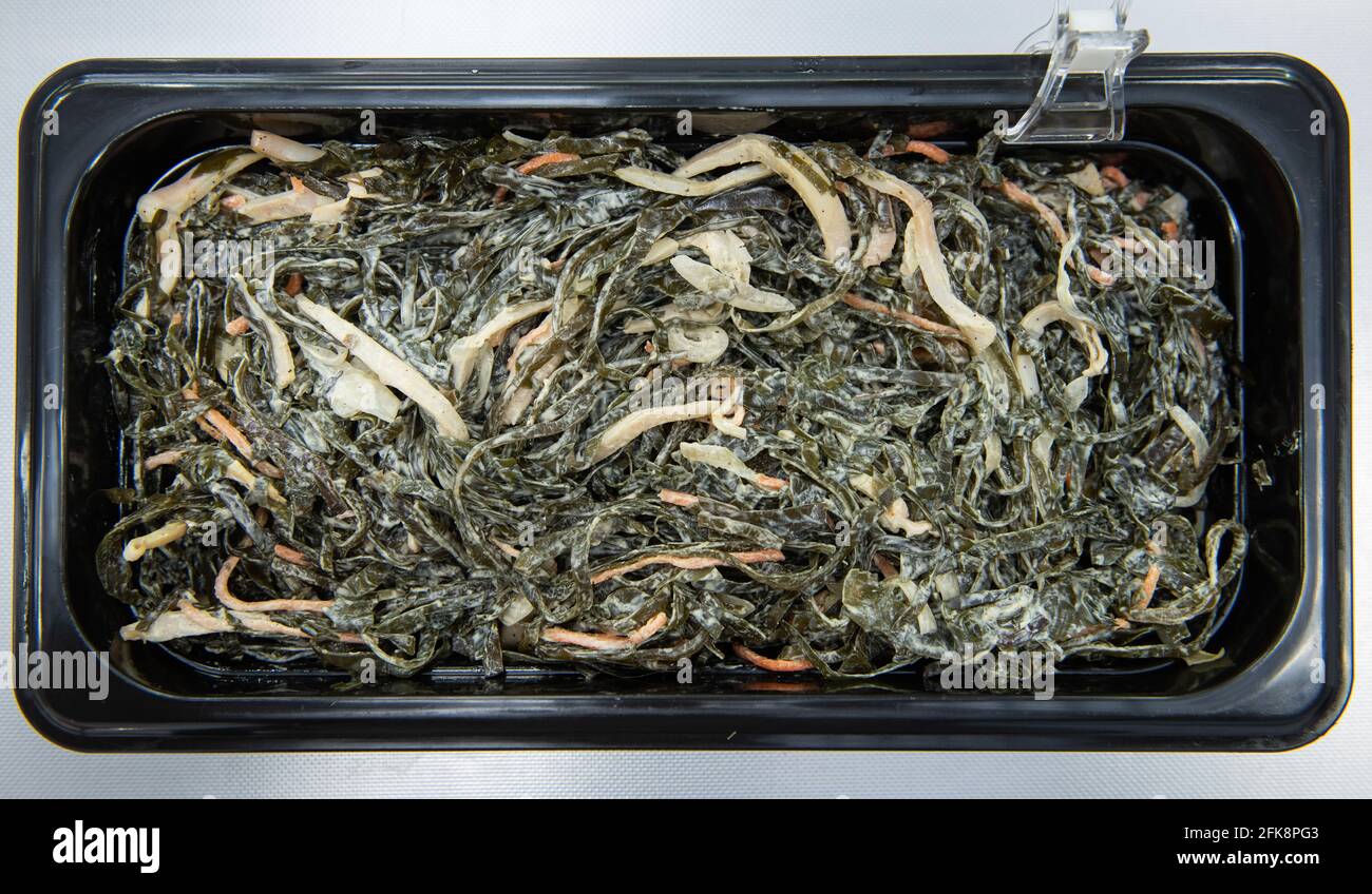Chuka wakame laminaria seaweed salad with calamary in plastic bowles ...