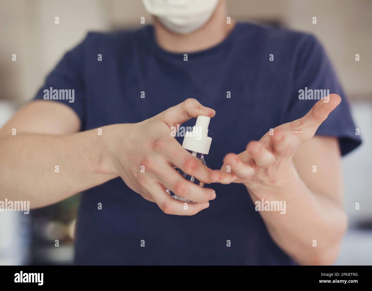 Male hands applying alcohol spray against coronavirus, close up. Man ...