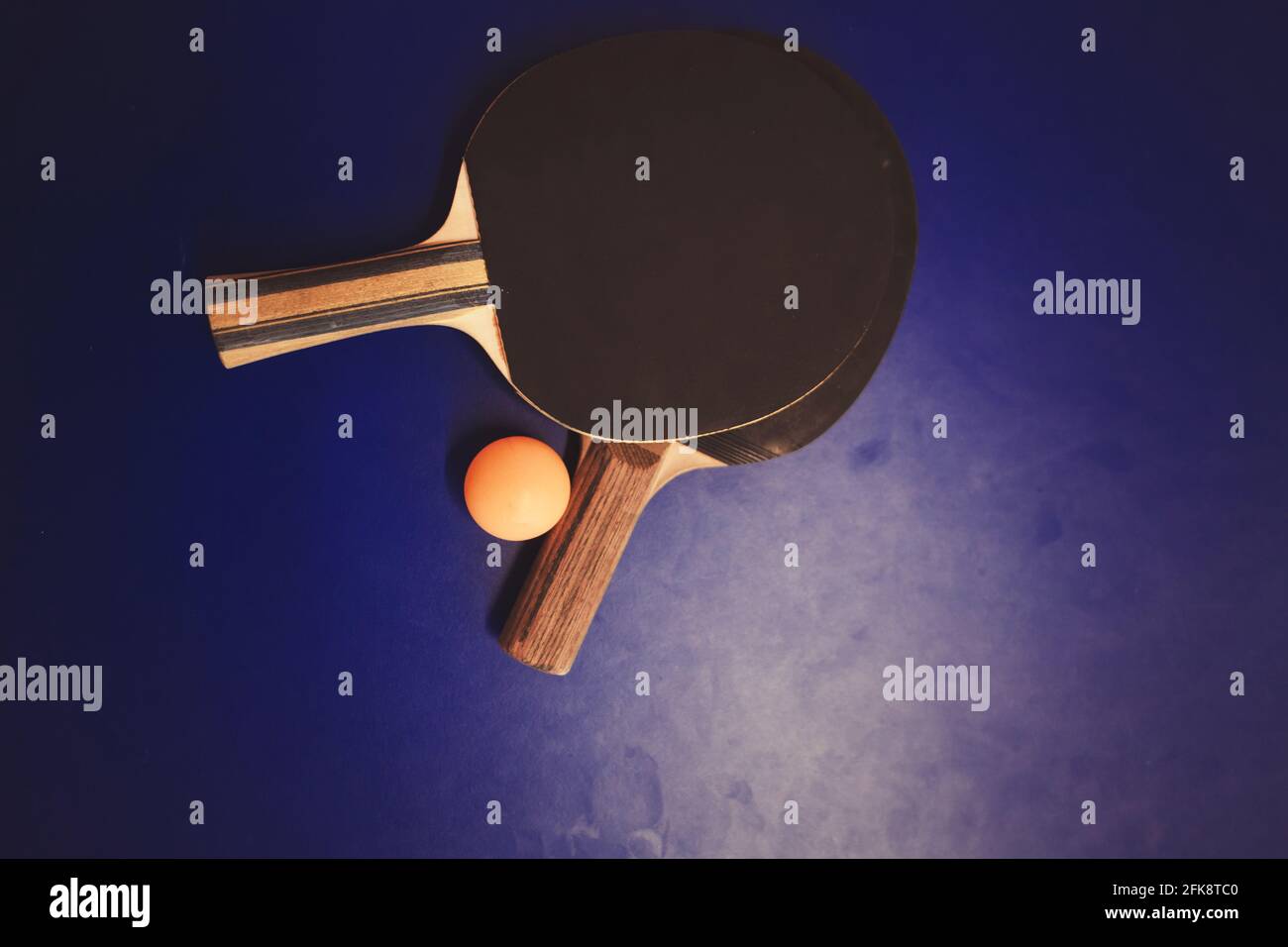 Blue table tennis or ping pong. Two table tennis or ping pong rackets ...