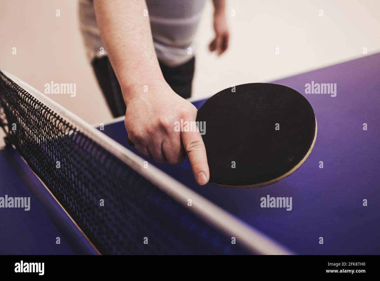 ping pong player holds a table tennis racket in his hand Stock Photo ...