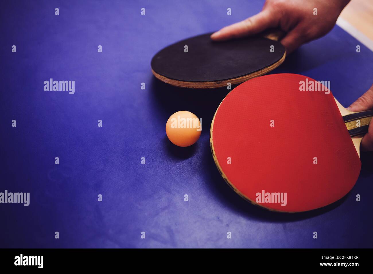 Blue table tennis or ping pong. Hands with two table tennis or ping ...