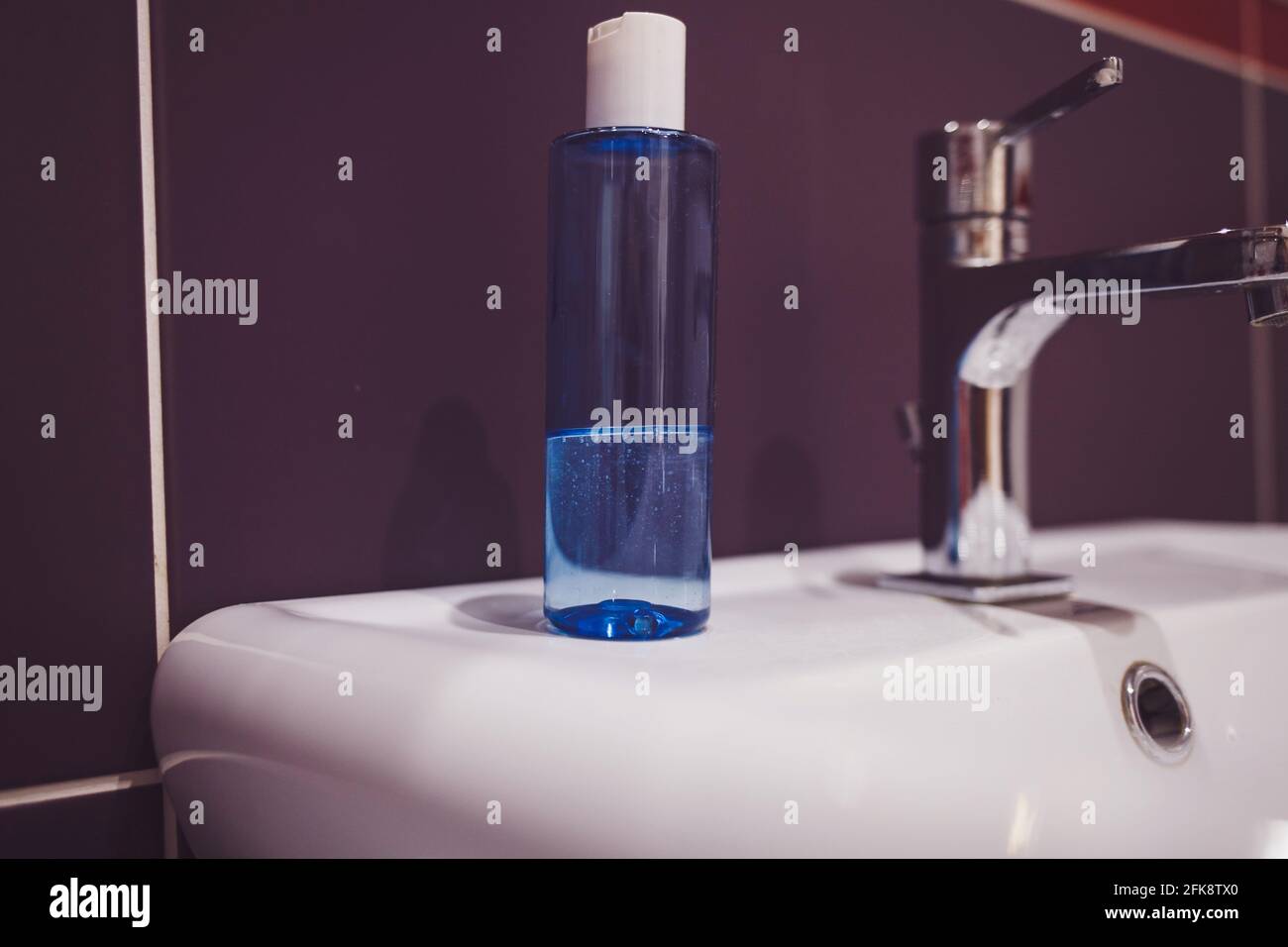 blue plastic bottle of liquid soap on the bathroom sink Stock Photo - Alamy
