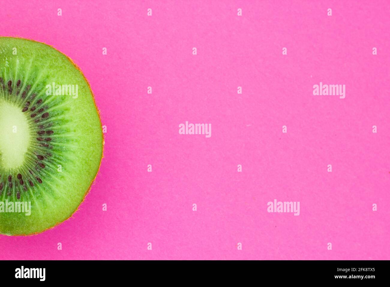 Cut kiwi fruits on pink background; colorful summer background; kiwi ...