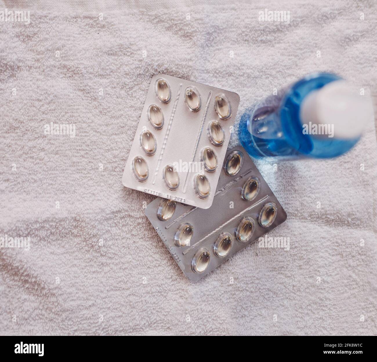 virus tablets in capsules and a bottle of antibacterial soap Stock ...