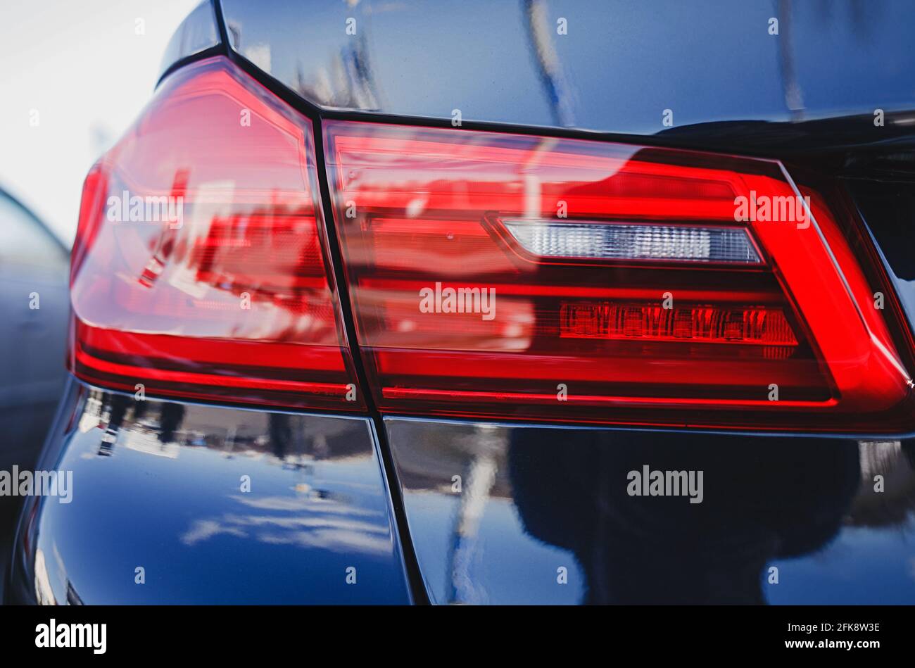 Detail on the rear light of a blue modern car Stock Photo - Alamy