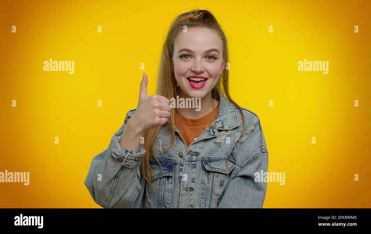 Teenager girl raises thumbs up agrees or gives positive reply ...