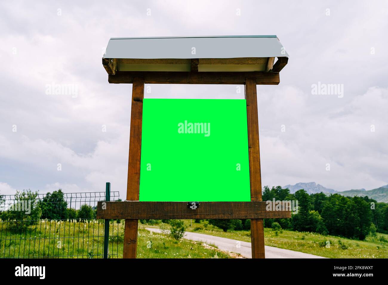 Blank wooden signpost in a road to forest Stock Photo - Alamy