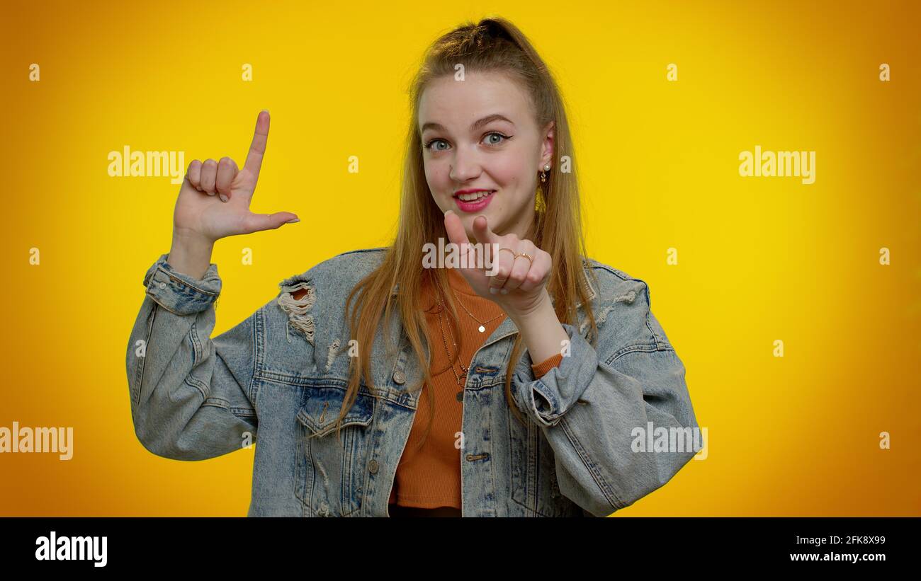 Girl showing loser gesture and pointing on you, blaming accusing for ...