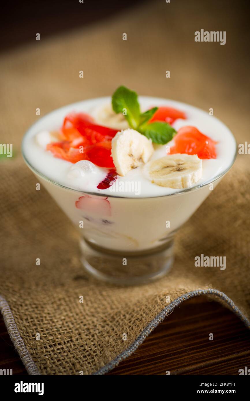 homemade sweet yogurt with bananas and pieces of fruit jelly Stock ...