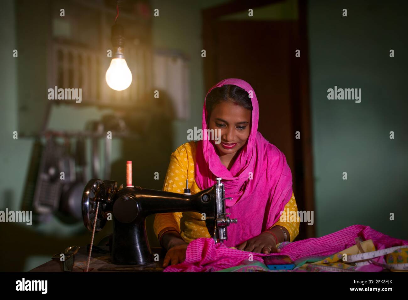 PORTRAIT OF A RURAL WOMAN SEWING CLOTHES Stock Photo - Alamy