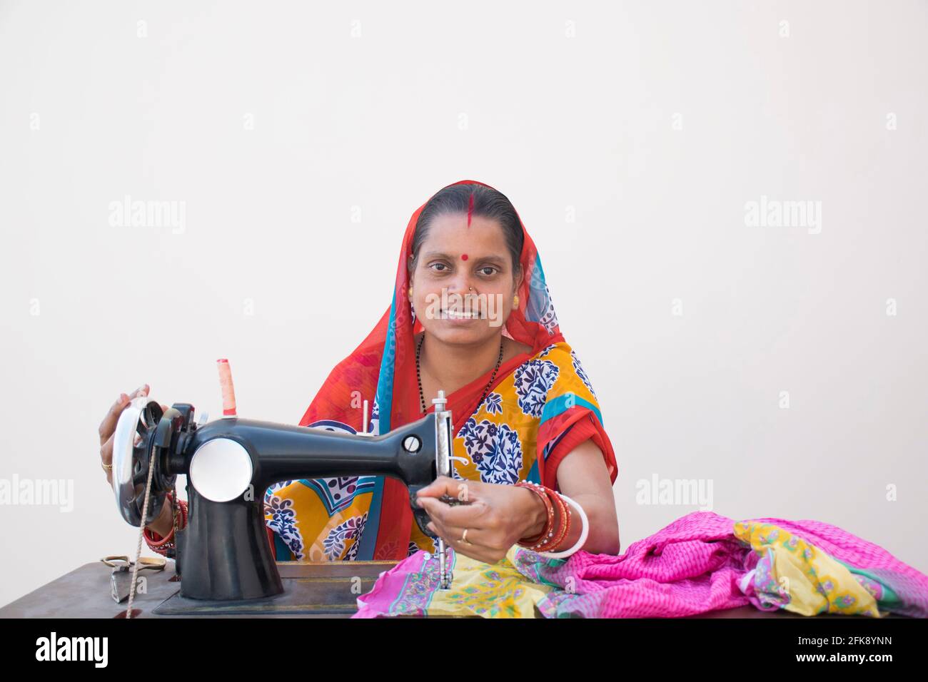 PORTRAIT OF A RURAL WOMAN SEWING CLOTHES Stock Photo - Alamy