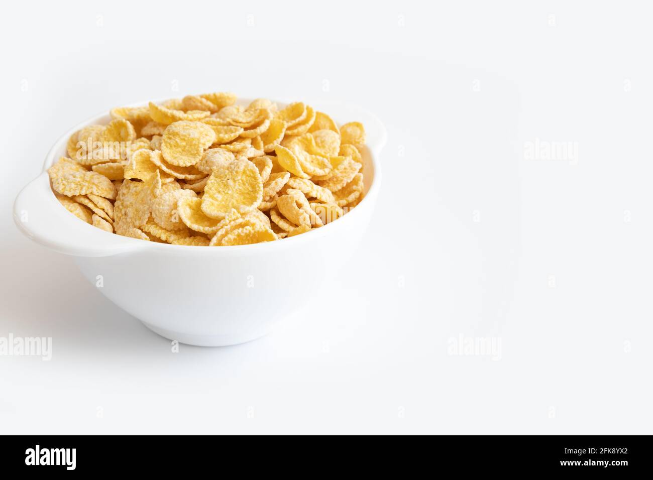 corn flake in bowl and empty space for text isolated on white ...