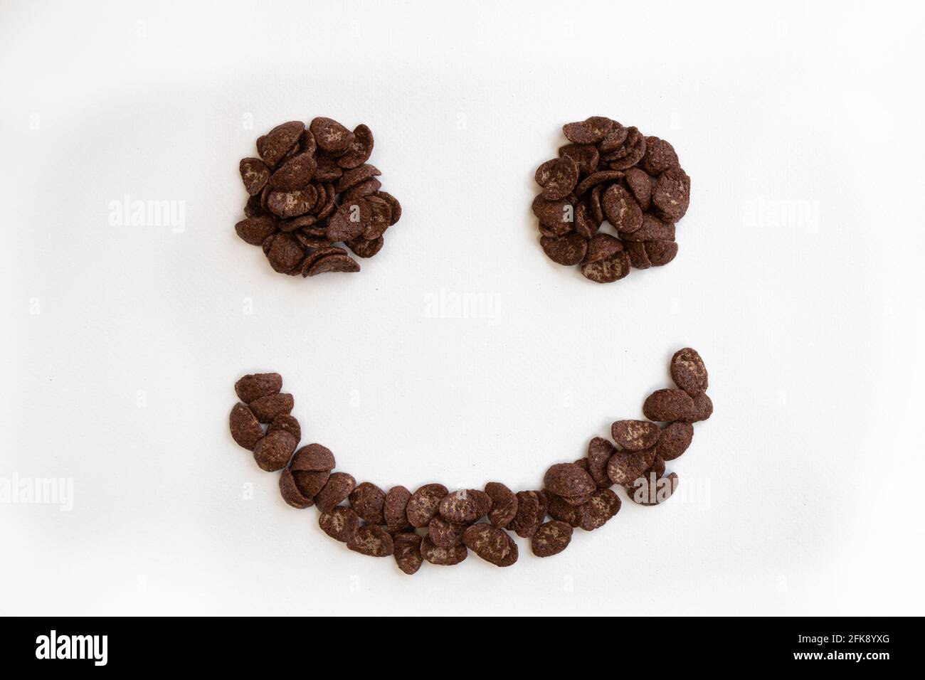 cereal muesli breakfast in the shape of smiling face on white ...