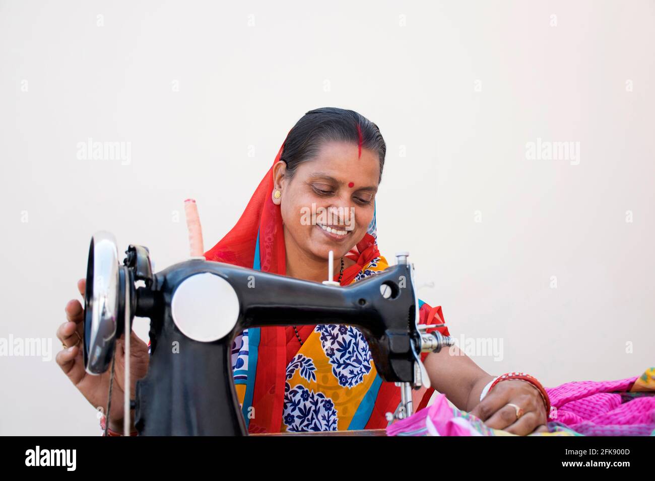PORTRAIT OF A RURAL WOMAN SEWING CLOTHES Stock Photo - Alamy