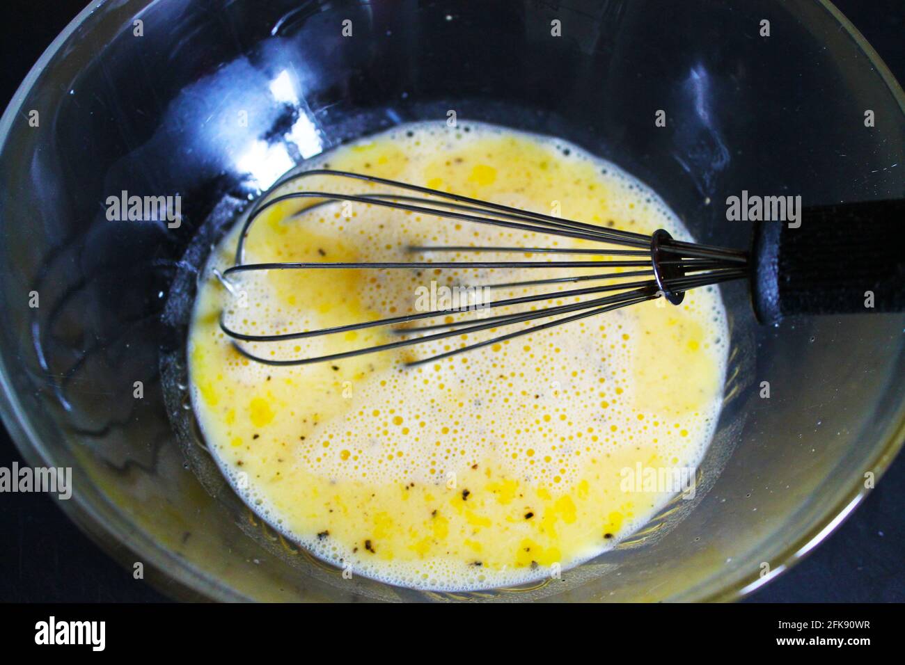 Close-up of a whisk in an egg mixture, in a clear glass bowl Stock ...