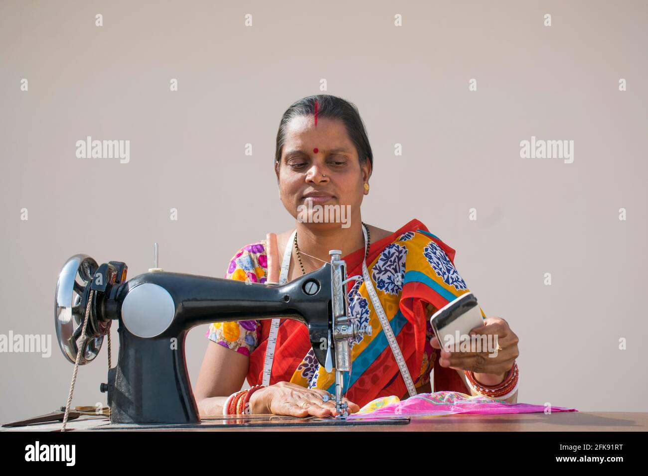 Indian woman using sewing machine hi-res stock photography and images ...