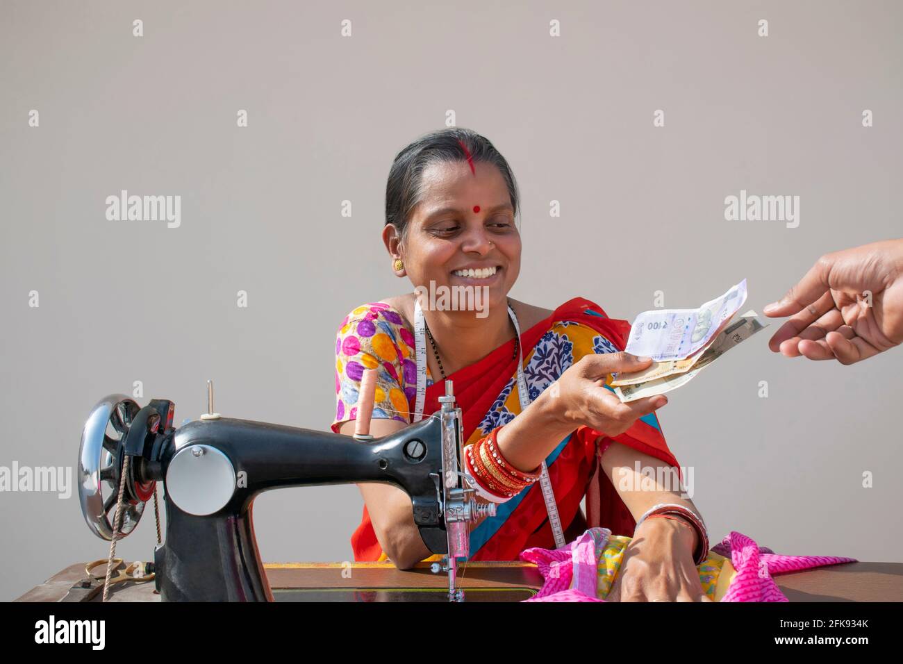Indian woman counting money hi-res stock photography and images - Alamy
