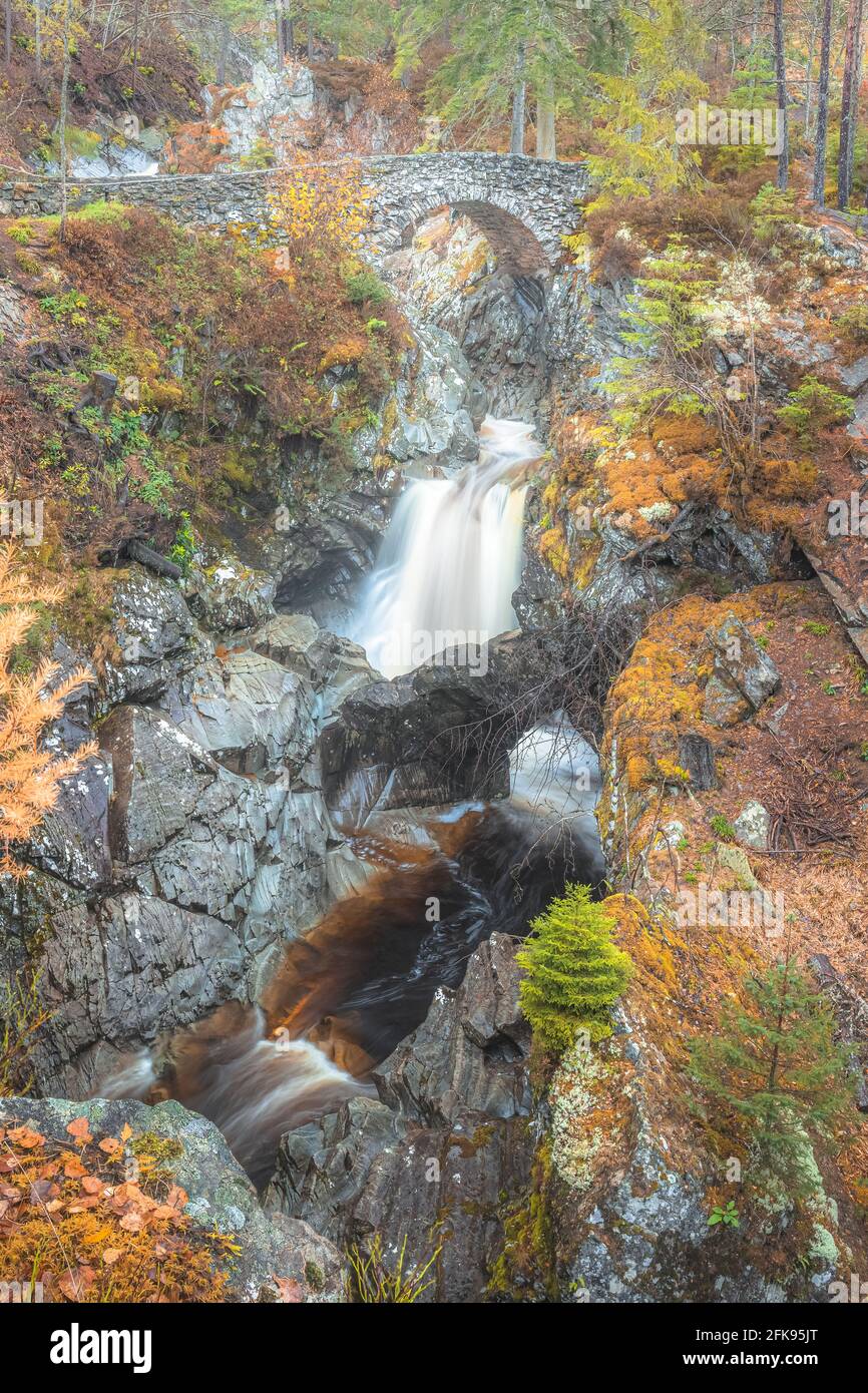 An old stone Roman bridge across waterfall Falls of Bruar in a ...
