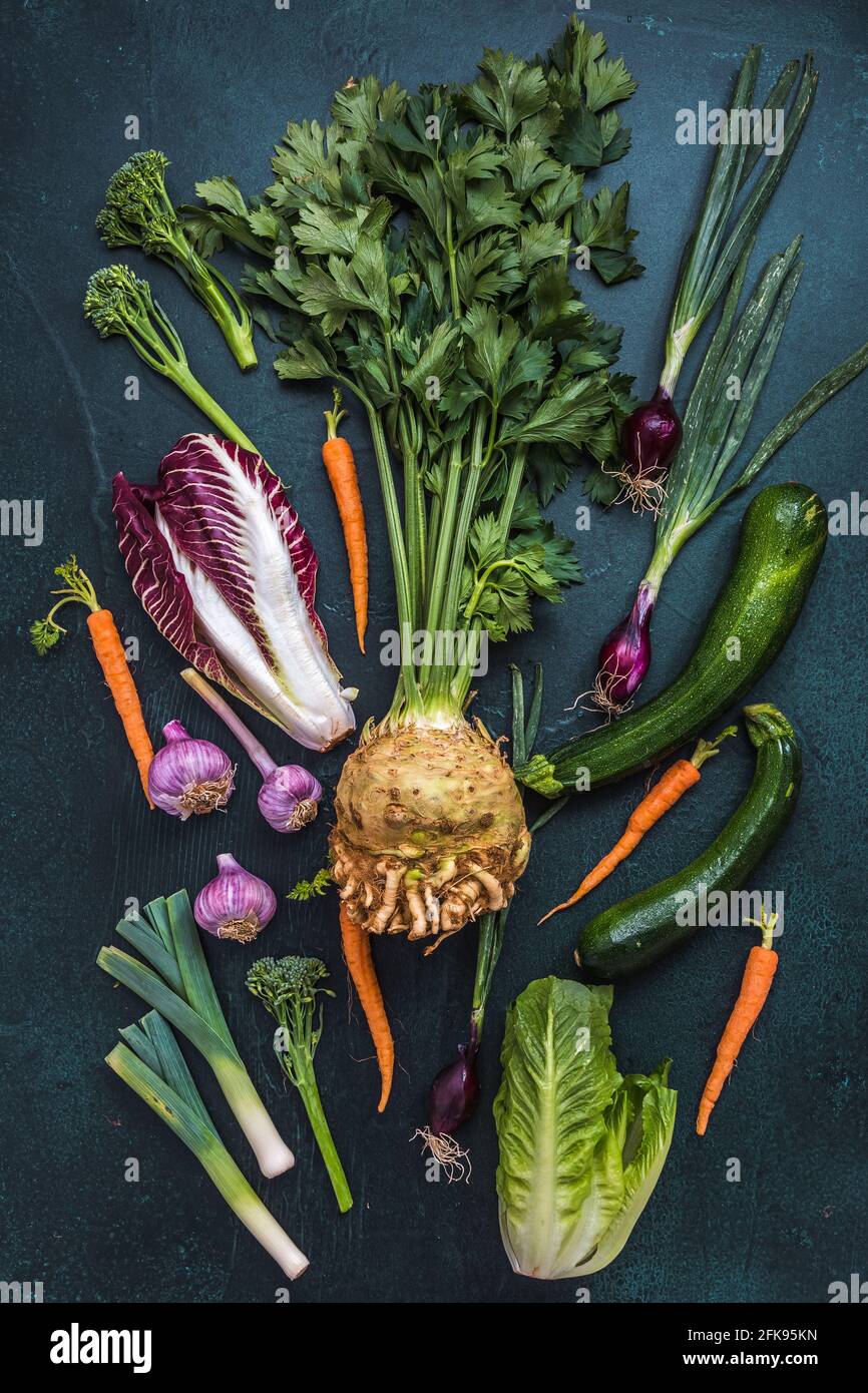 Variety of vegetables on dark background, vertical top view, concept of ...
